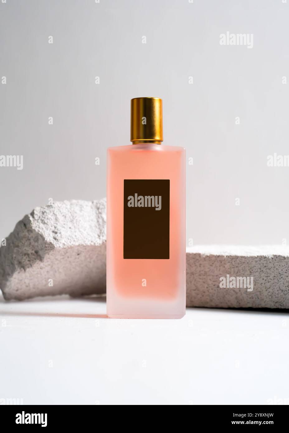 An elegant peach color spray perfume bottle showcased against a clean ...