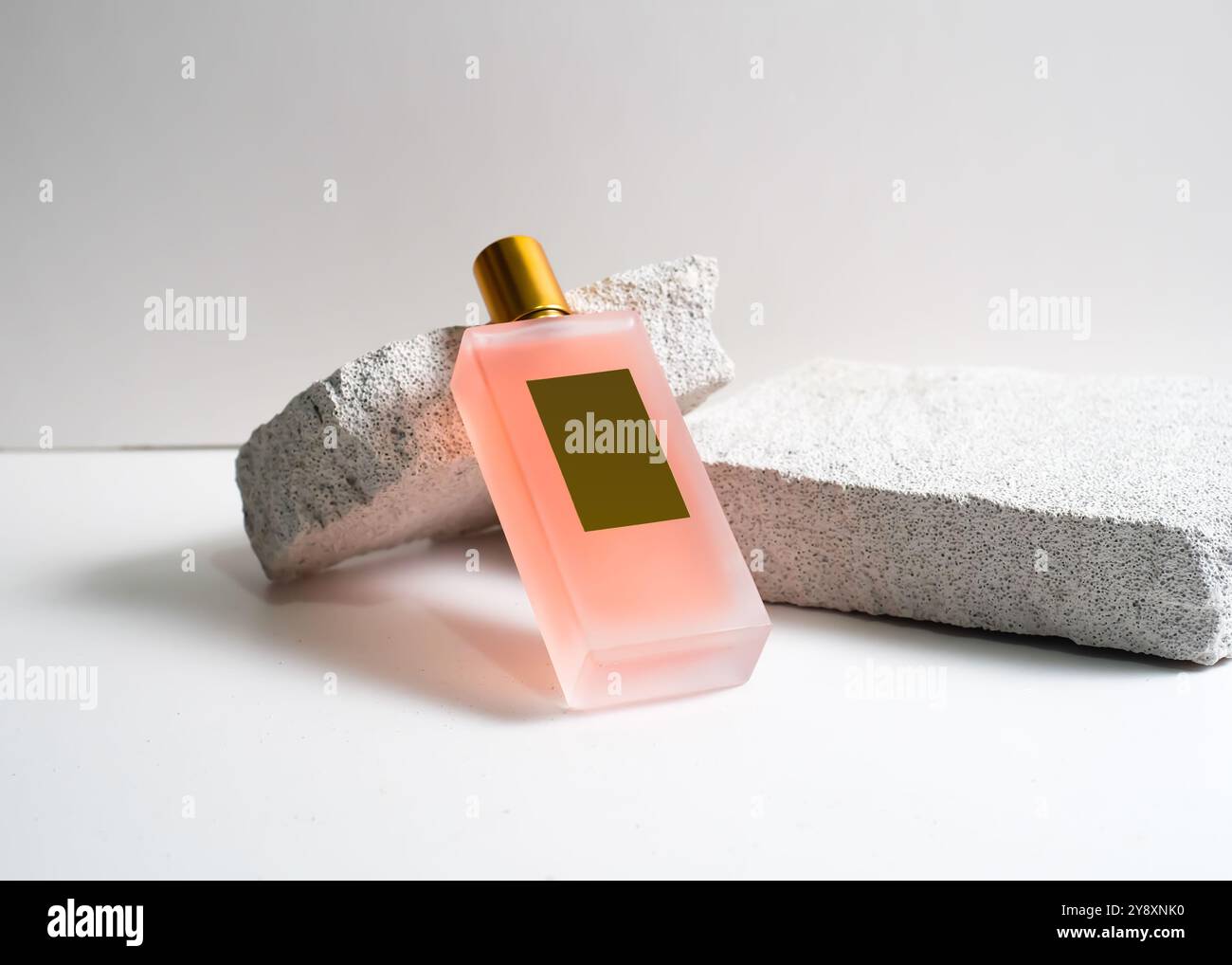 An elegant peach color spray perfume bottle showcased against a clean ...
