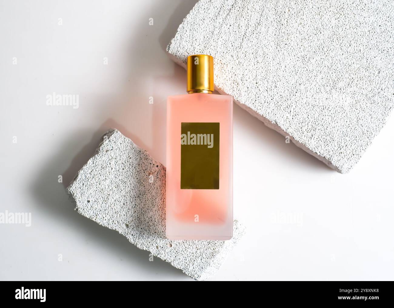 An elegant peach color spray perfume bottle showcased against a clean ...