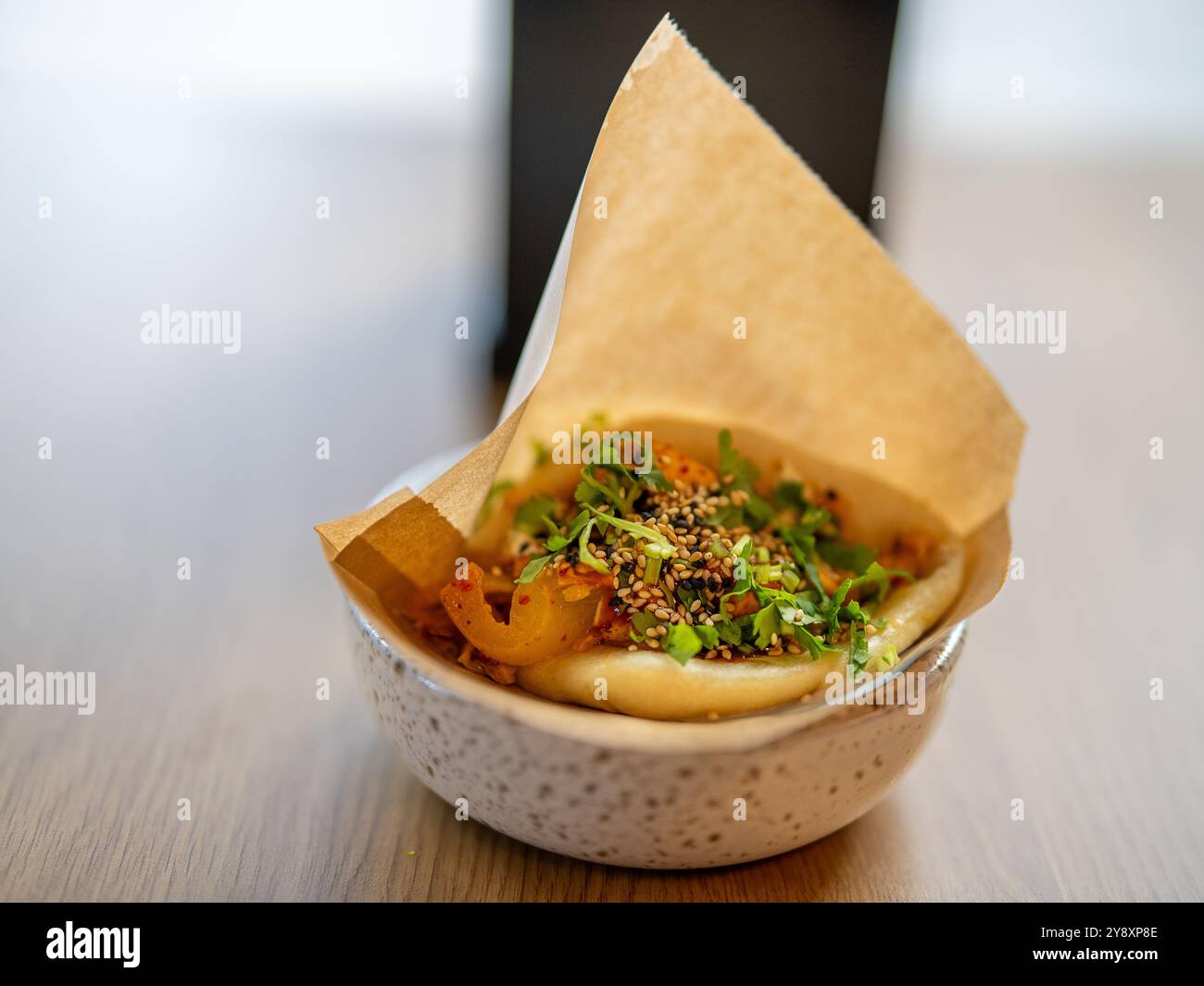 Korean style Bao Bun filled with chicken and marinated vegetables Stock ...