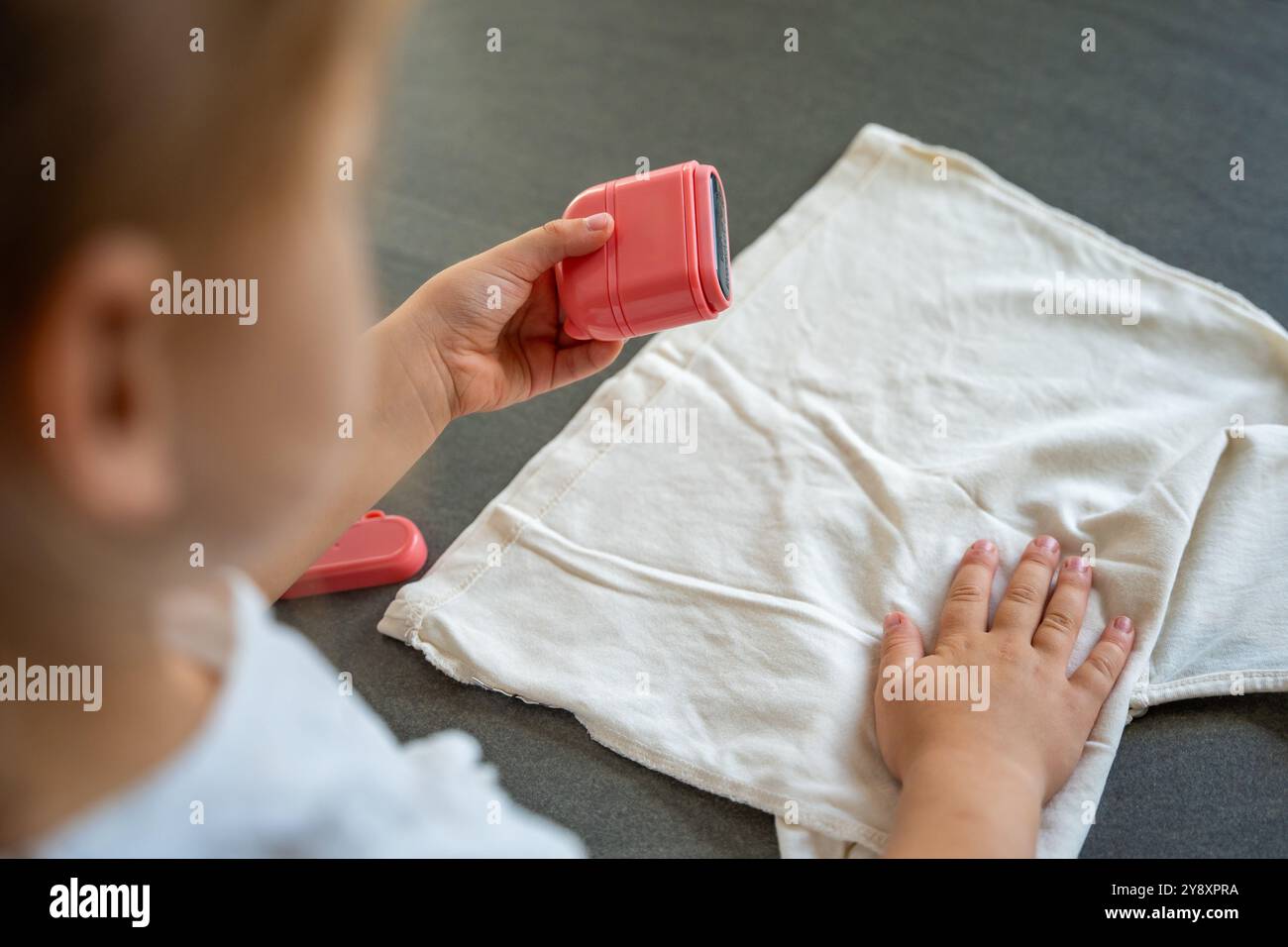 Back view of little girl with a stamp with a name for signing children ...