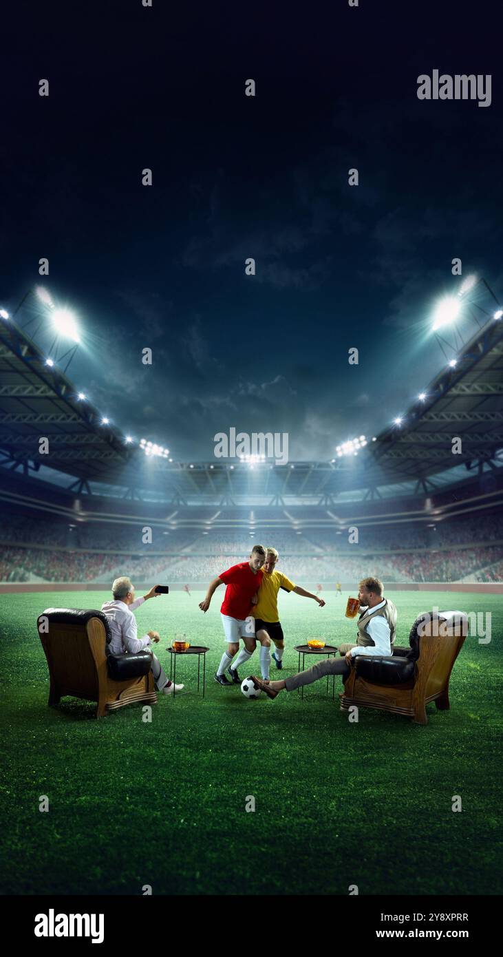 Two mates in formal wear, sitting on stadium while soccer players in ...