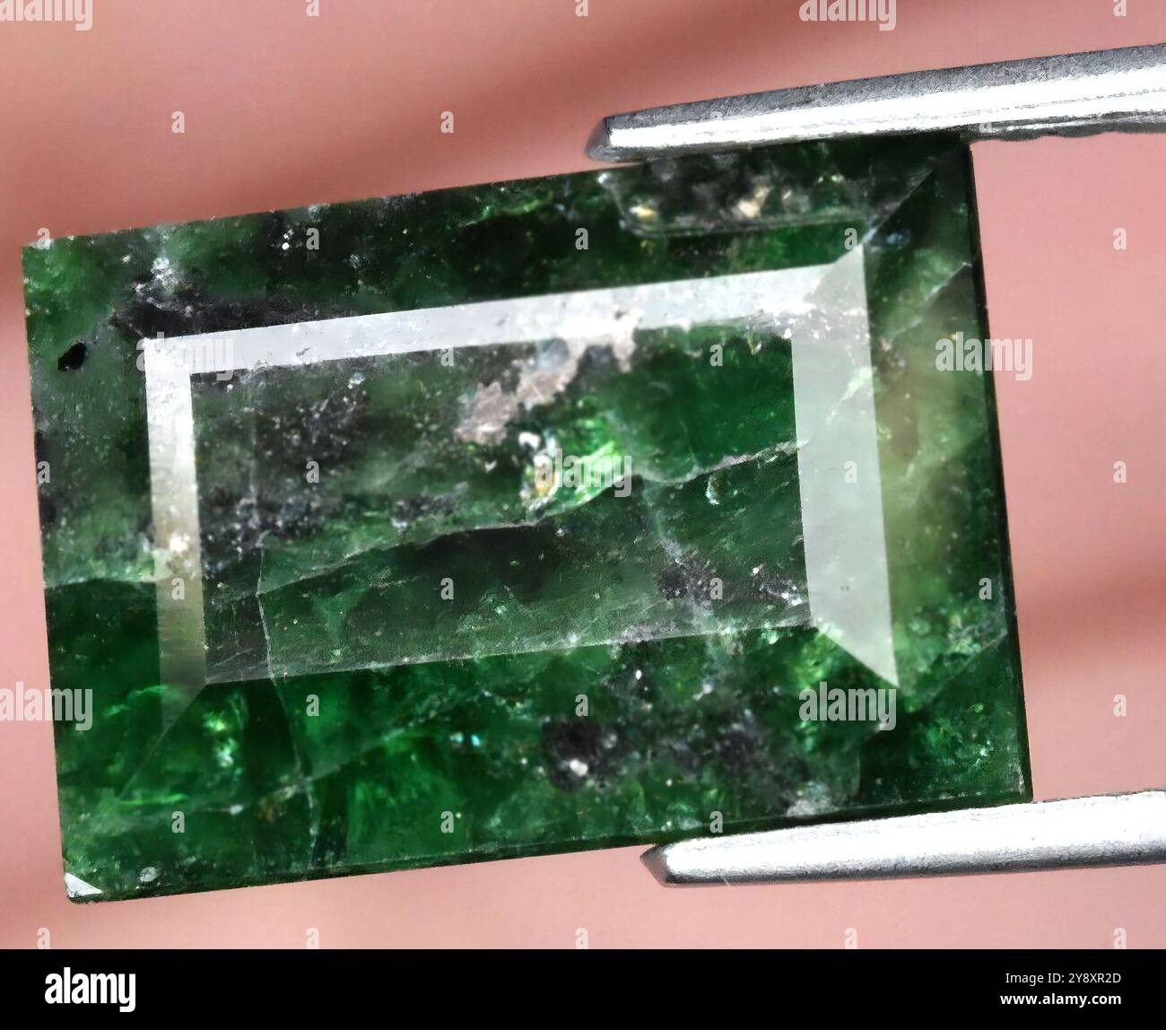 A Glimmering Green Emerald Cut Stone Showcasing Intricate Natural ...