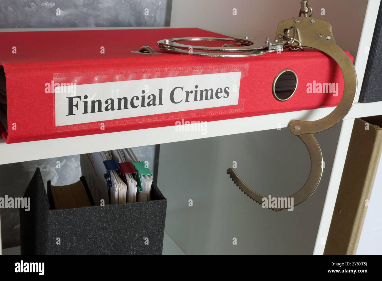 Financial crimes folder and handcuffs. Law enforcement Stock Photo - Alamy
