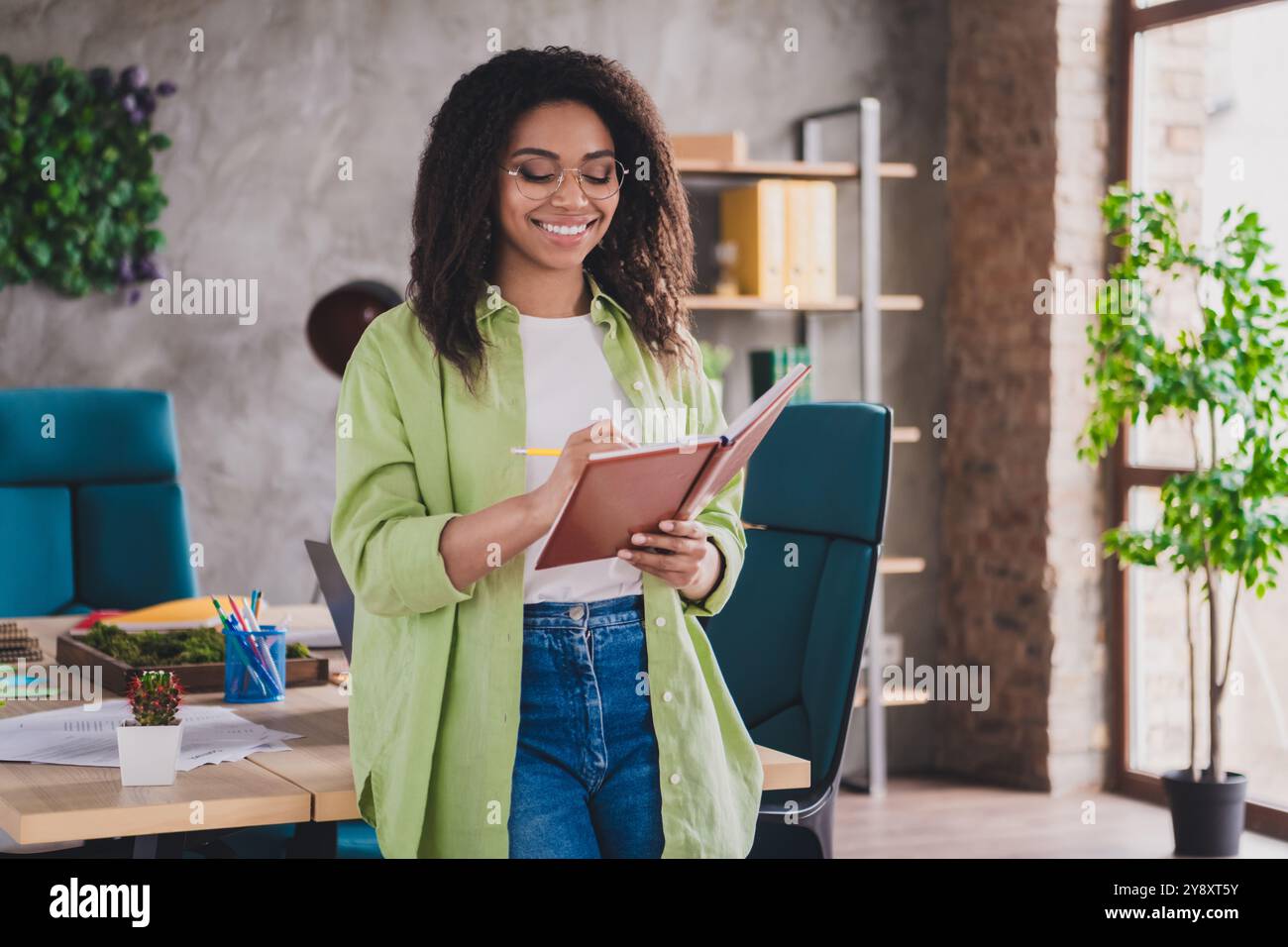 Portrait of young corporate lady pen write notepad wear shirt loft ...