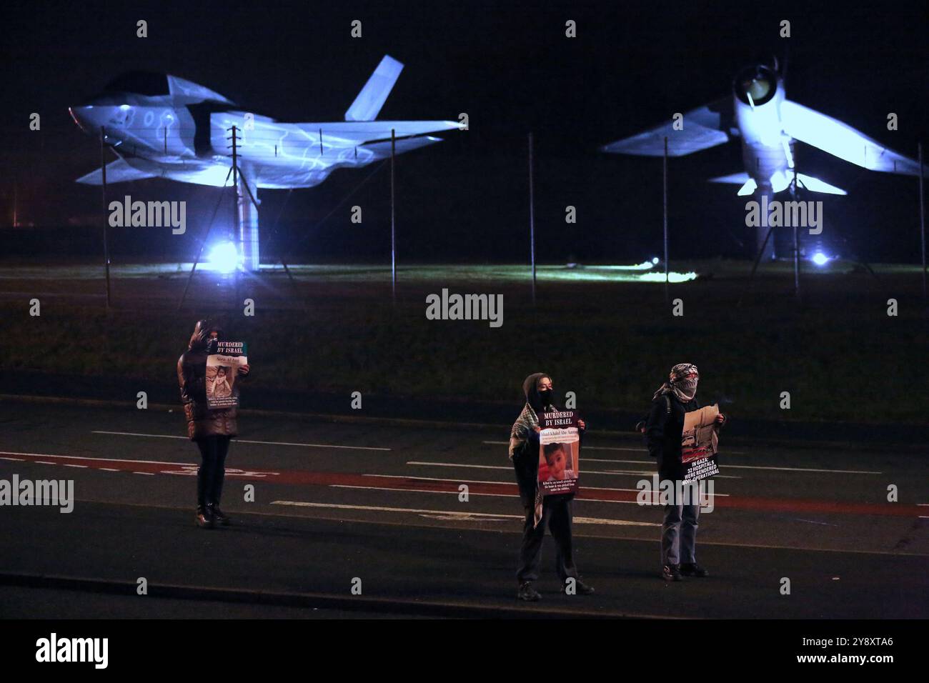 October 7, 2024, Blackburn, England, UK: A protester holds signs ...