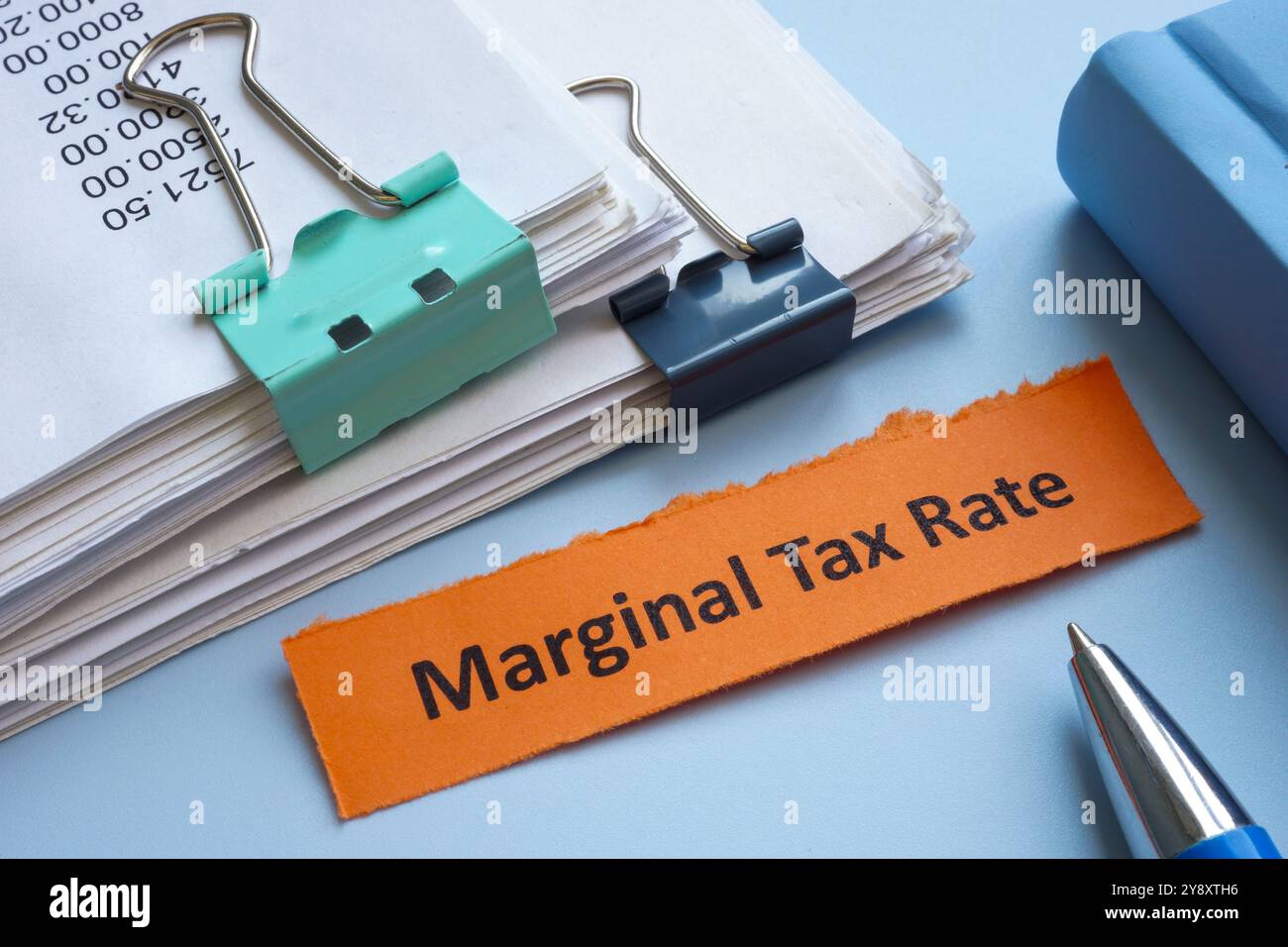 Stack of papers with label marginal tax rate Stock Photo - Alamy