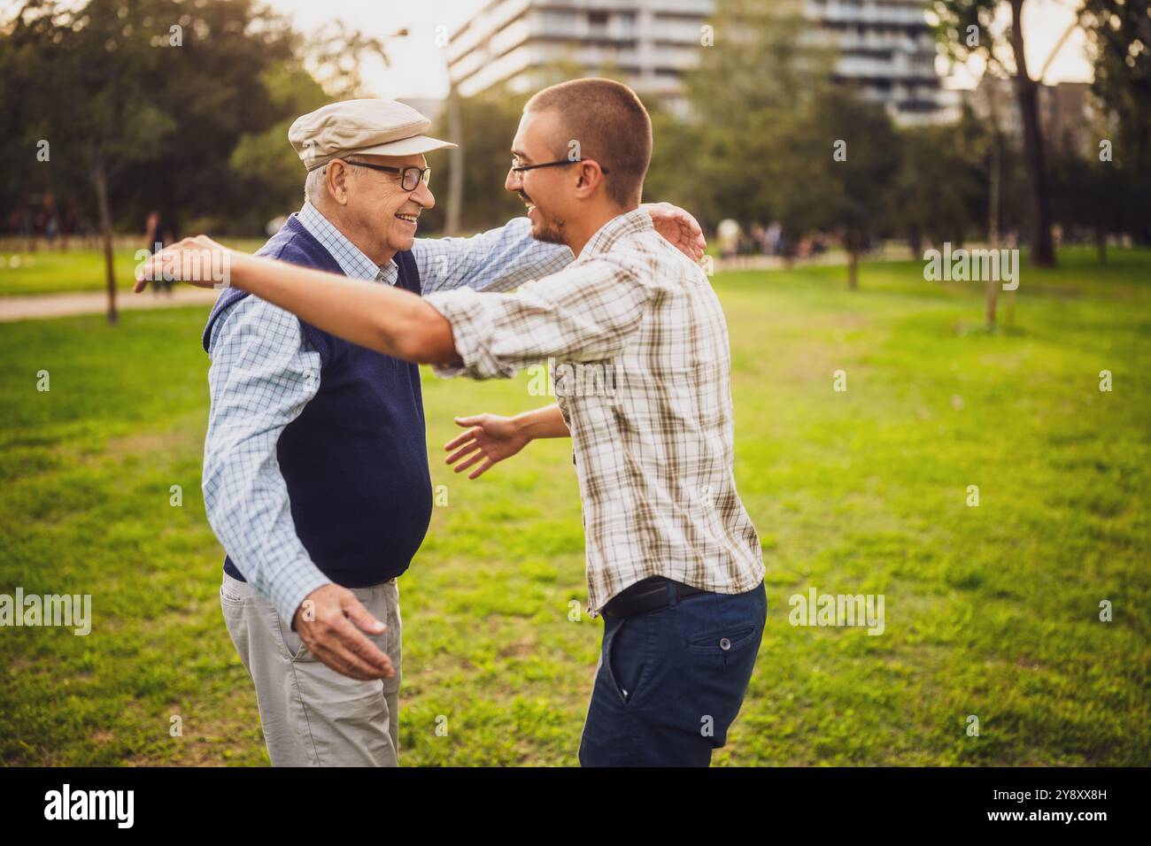 Happy grandfather and grandson are hugging and embracing in park Stock ...