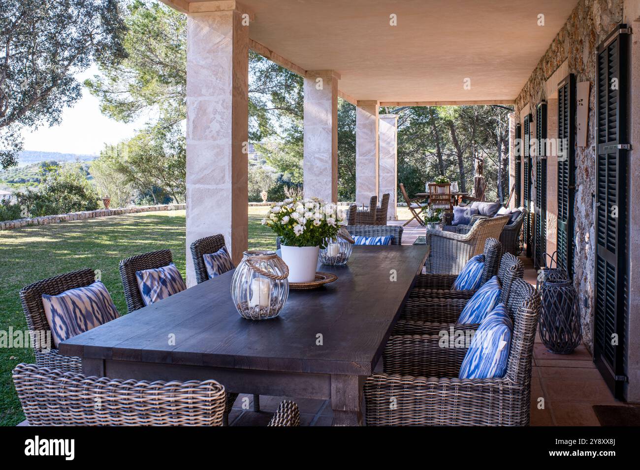 Wooden al fresco dining table and chairs on terrace outside Spanish ...