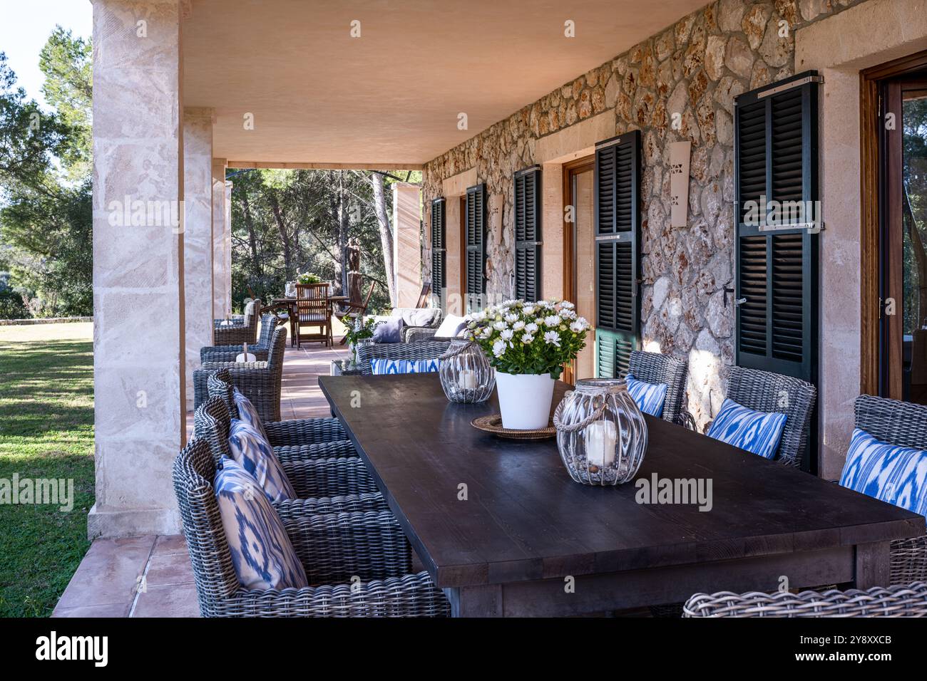 Wooden al fresco dining table and chairs on terrace outside Spanish ...