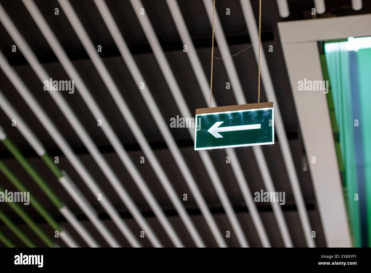 There is a bright green exit sign that features an arrow distinctly ...