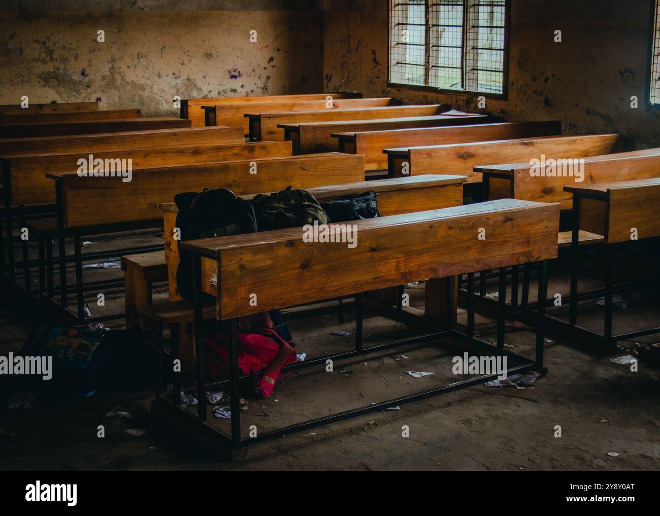 a classroom with a wooden ceiling, a blackboard, a window and a wooden ...