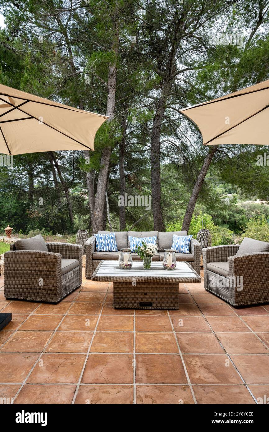 Parasols shade seating on tiled terrace outside Spanish villa, Mallorca ...