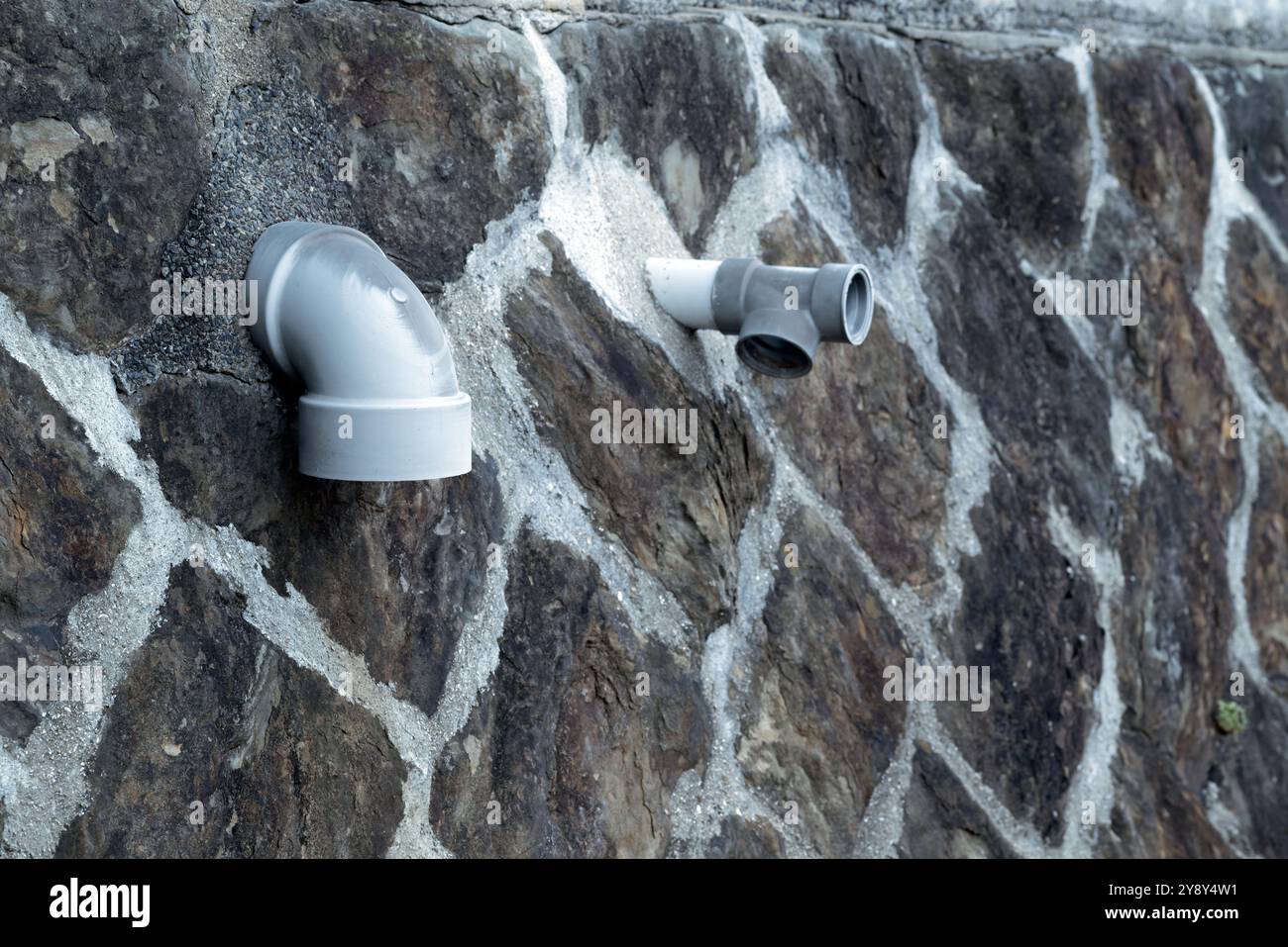 Water and waste drainage plastic pipe tubes through a retaining wall ...