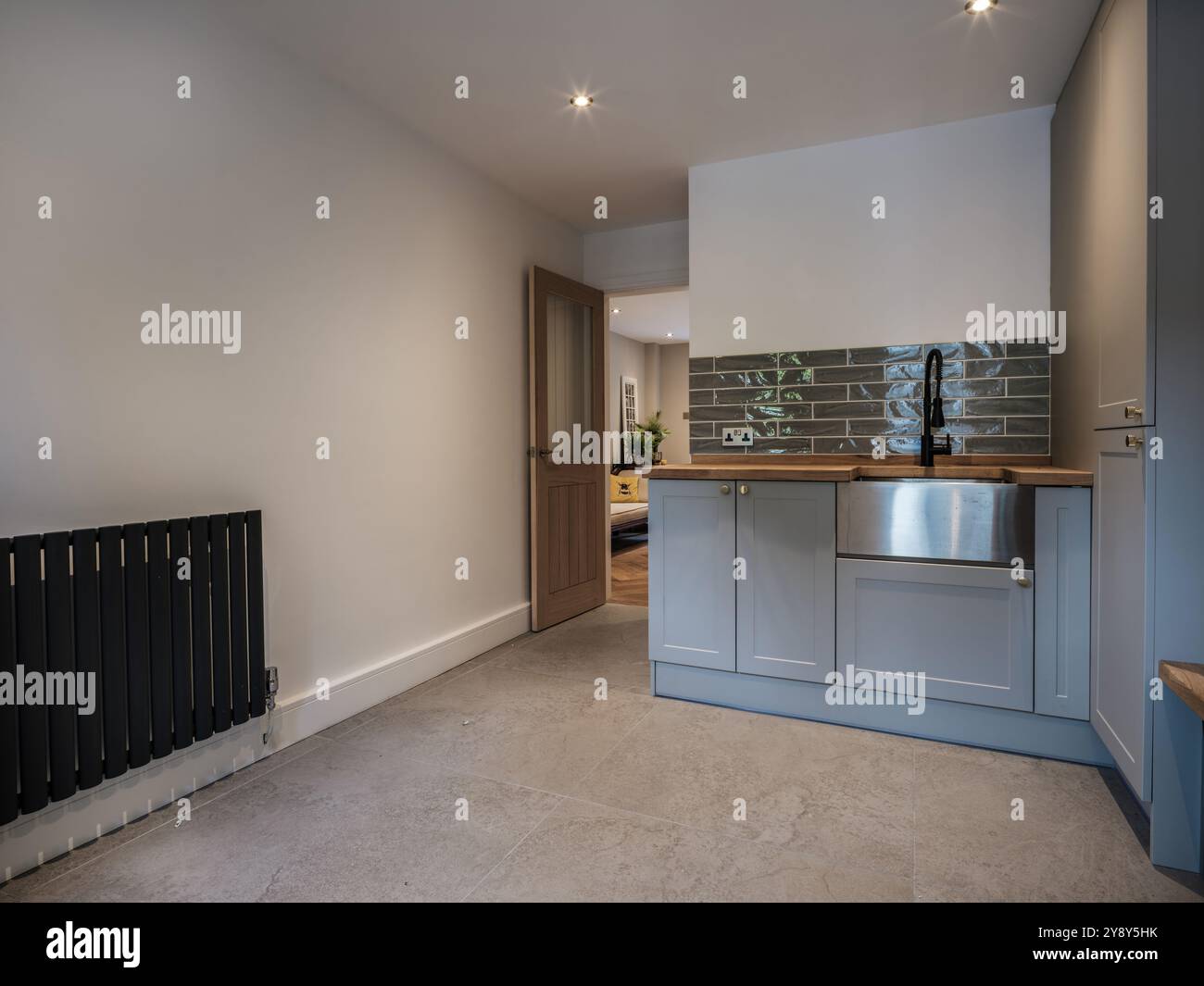 Luxury stylish utility laundry room with bench seat and fitted cabinets ...