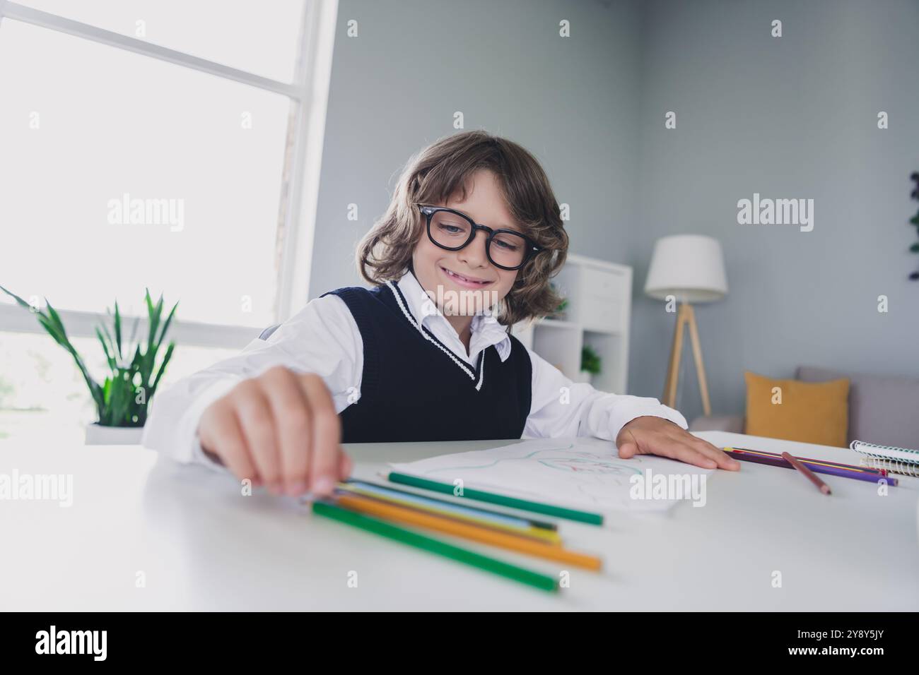 Portrait of diligent adorable schoolkid hold pencil drawing arts ...
