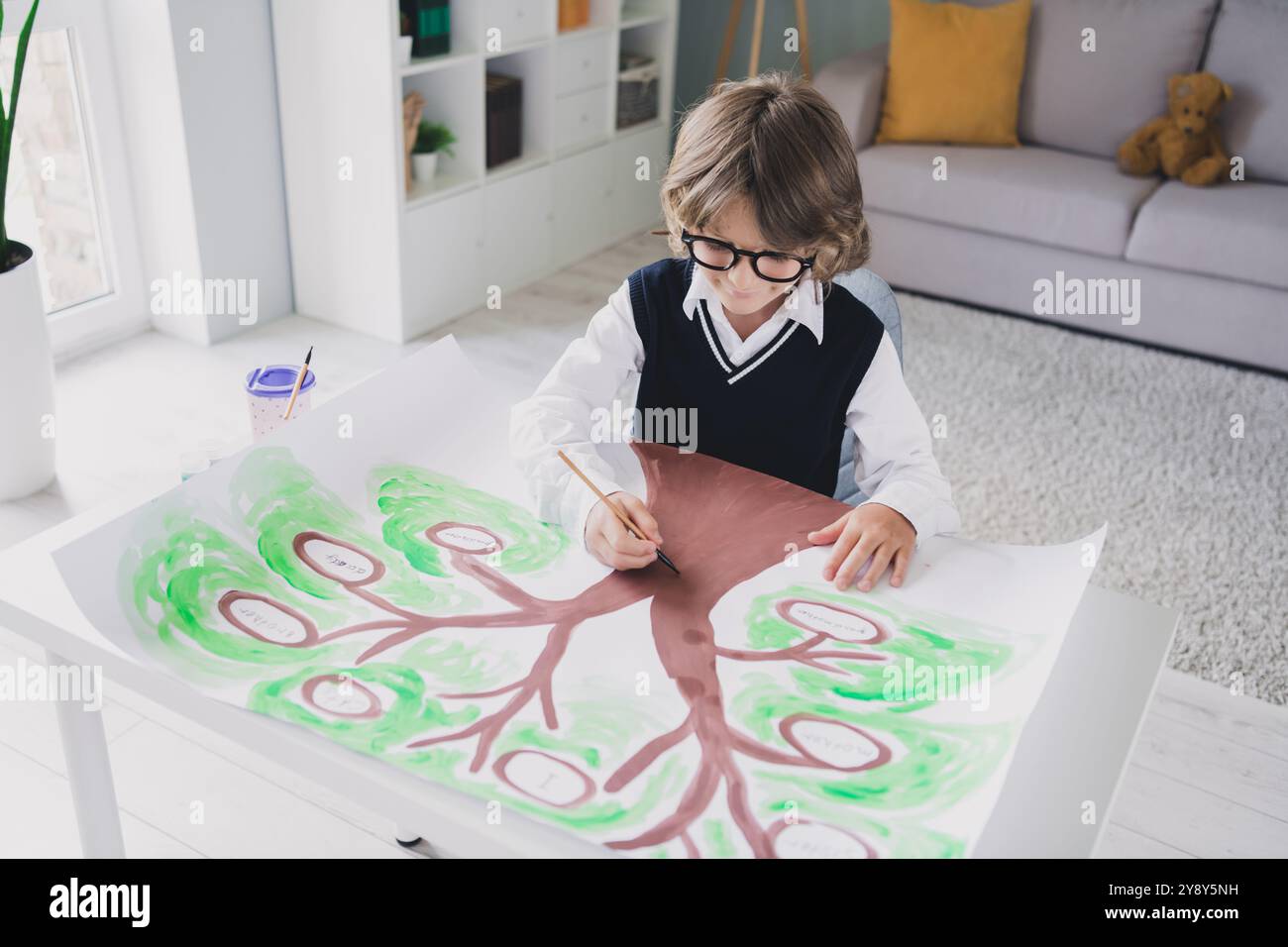 Portrait of charming pretty cute intelligent boy wearing vest painting ...
