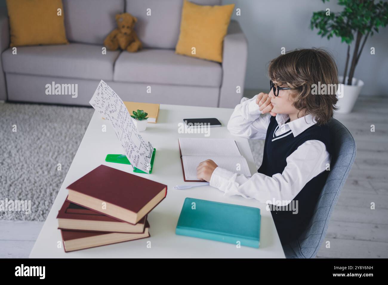 Portrait of charming adorable cute clever intelligent boy studying from ...