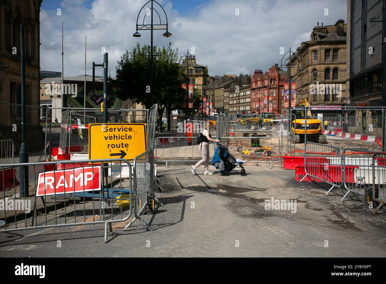 A woman walks through the city of Bradford in West Yorkshire which is ...