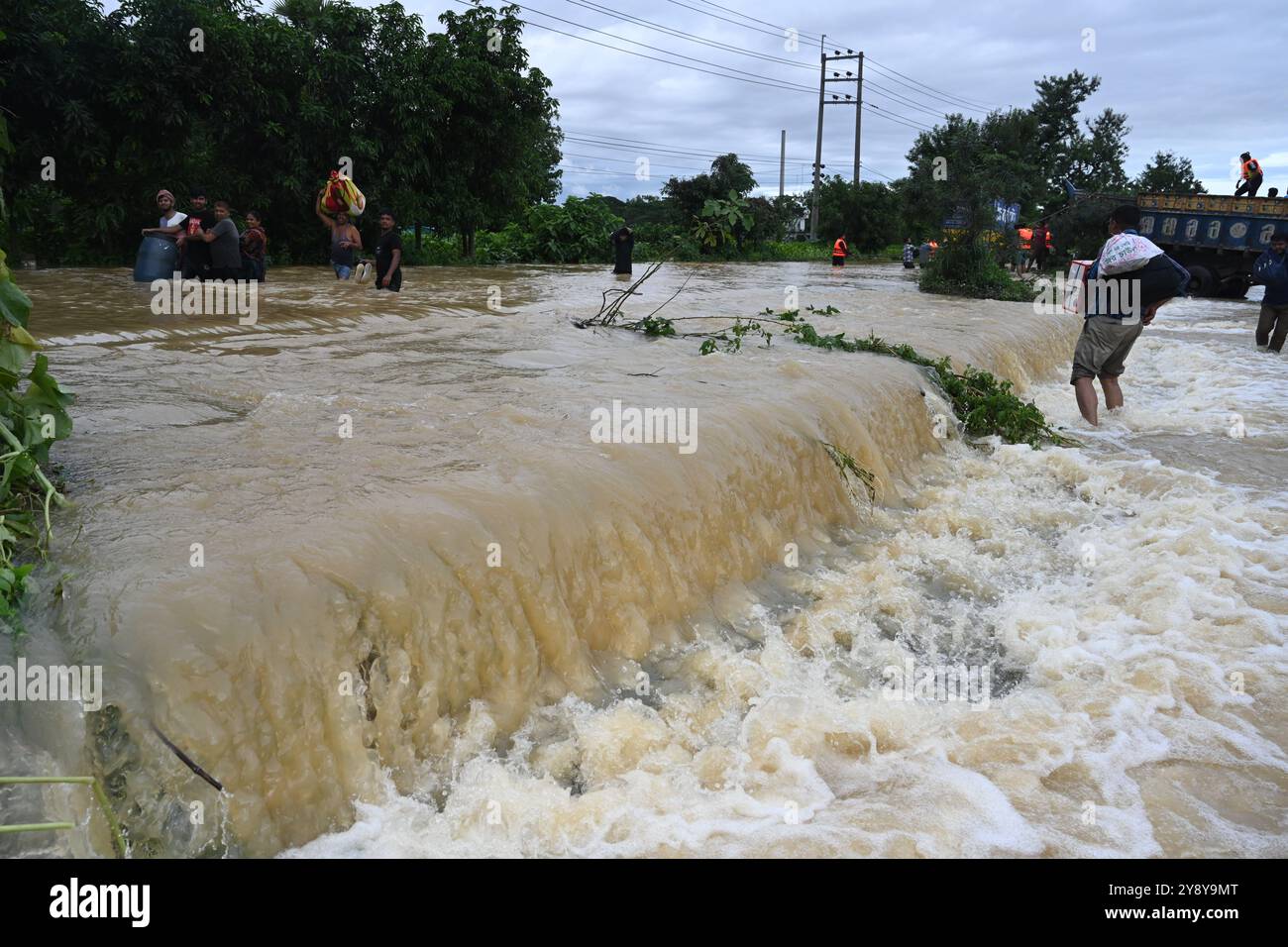 People wade through floodwaters in Feni District, Bangladesh, on August ...