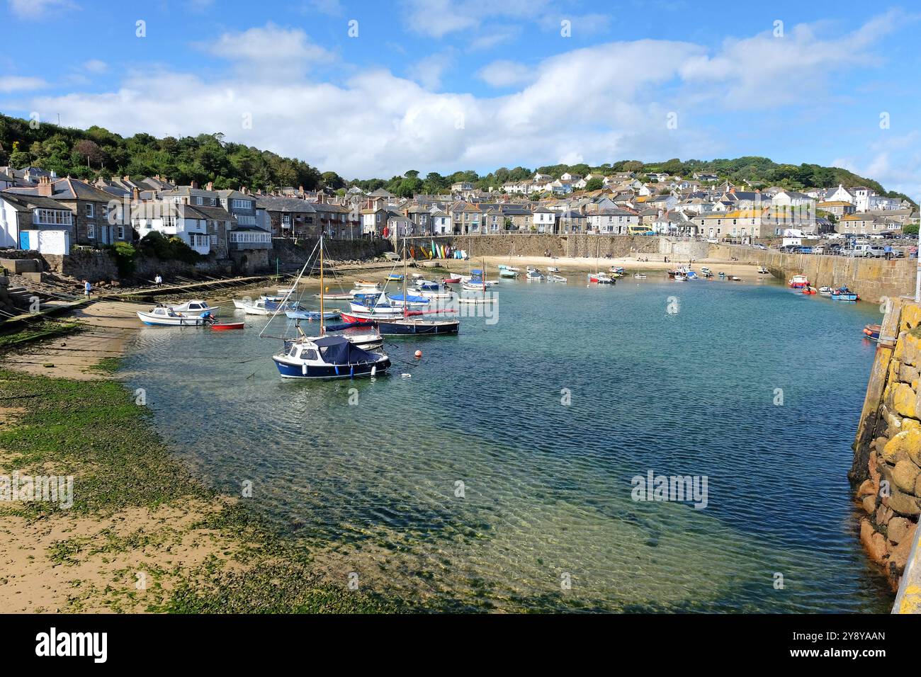 Mousehole fishing village harbour, at low tide, on the shore of Mount's ...