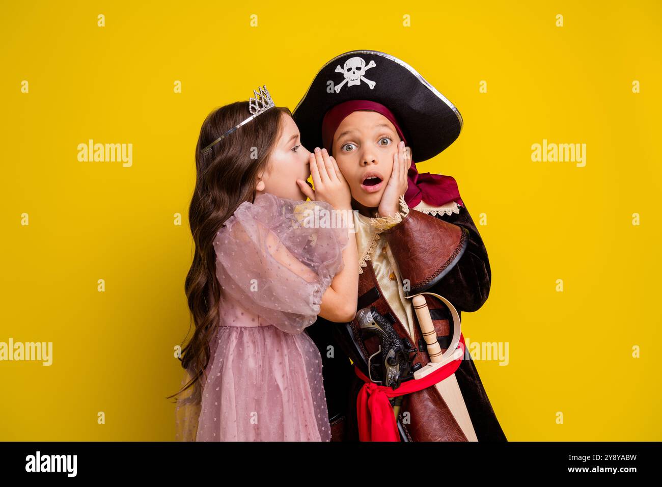 Portrait of two small kids halloween pirate princess costume whisper ...