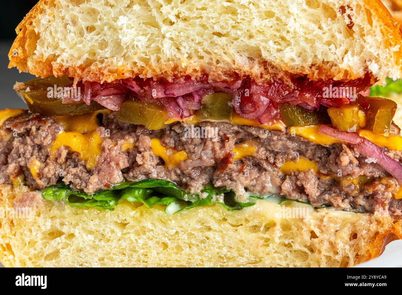 Closeup on cheeseburger layers slice Stock Photo - Alamy