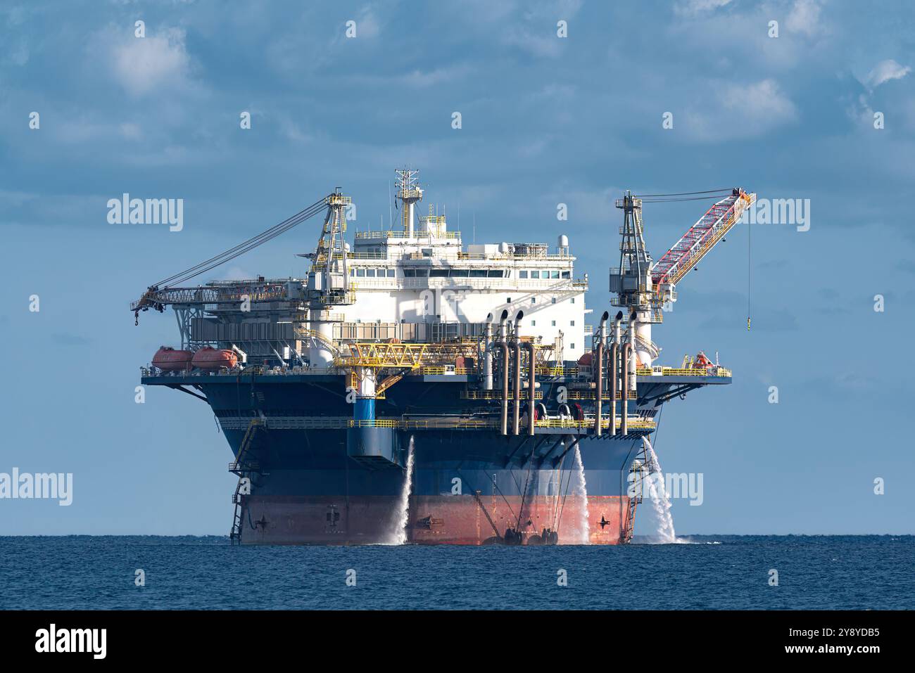 Offshore Accommodation platform pumping water into the sea on a cloudy ...