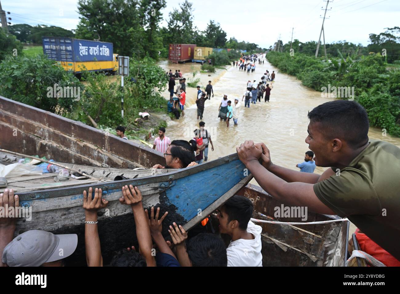People wade through floodwaters in Feni District, Bangladesh, on August ...