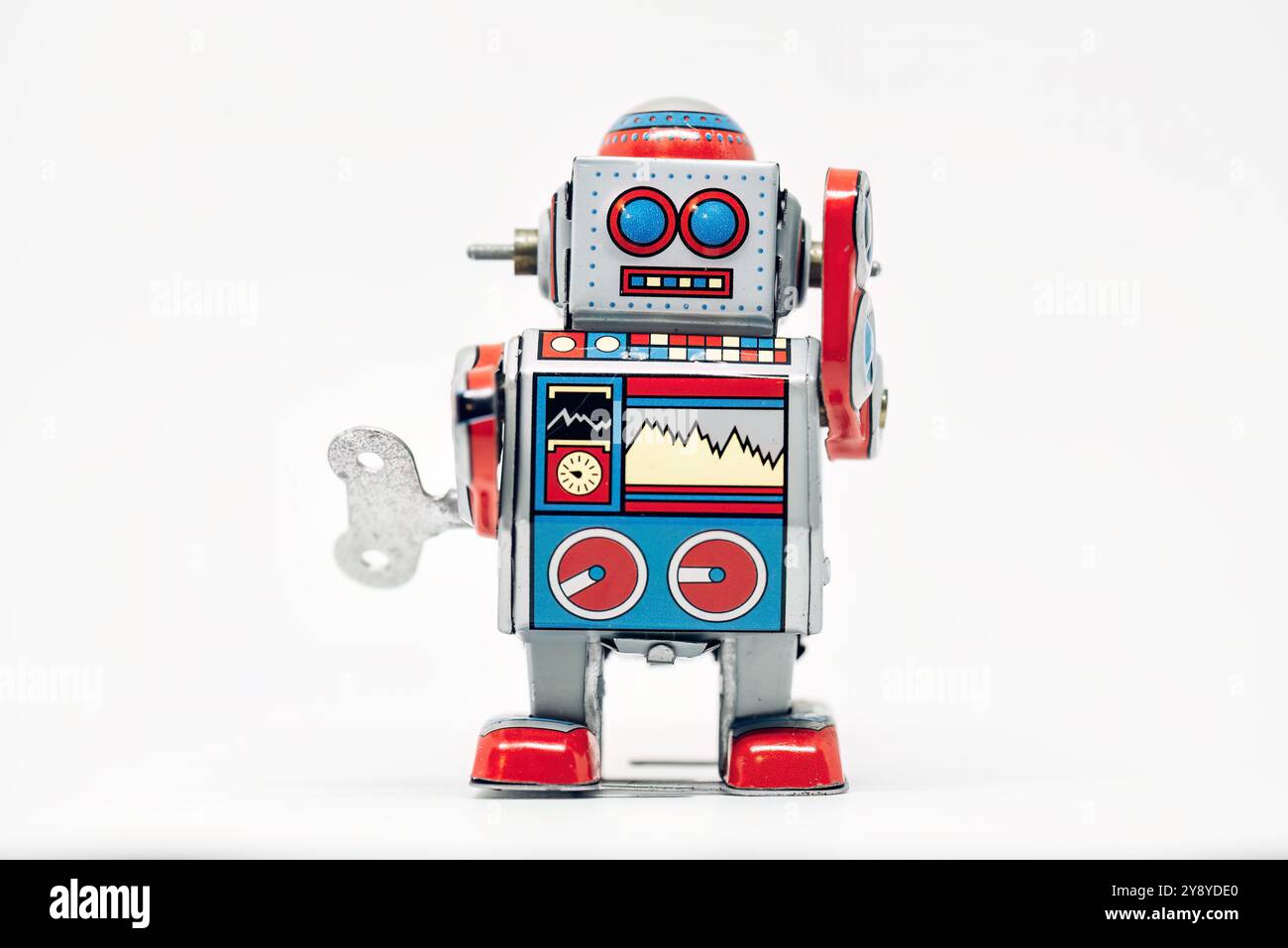 Vintage wind-up toy robot on white background evokes childhood ...