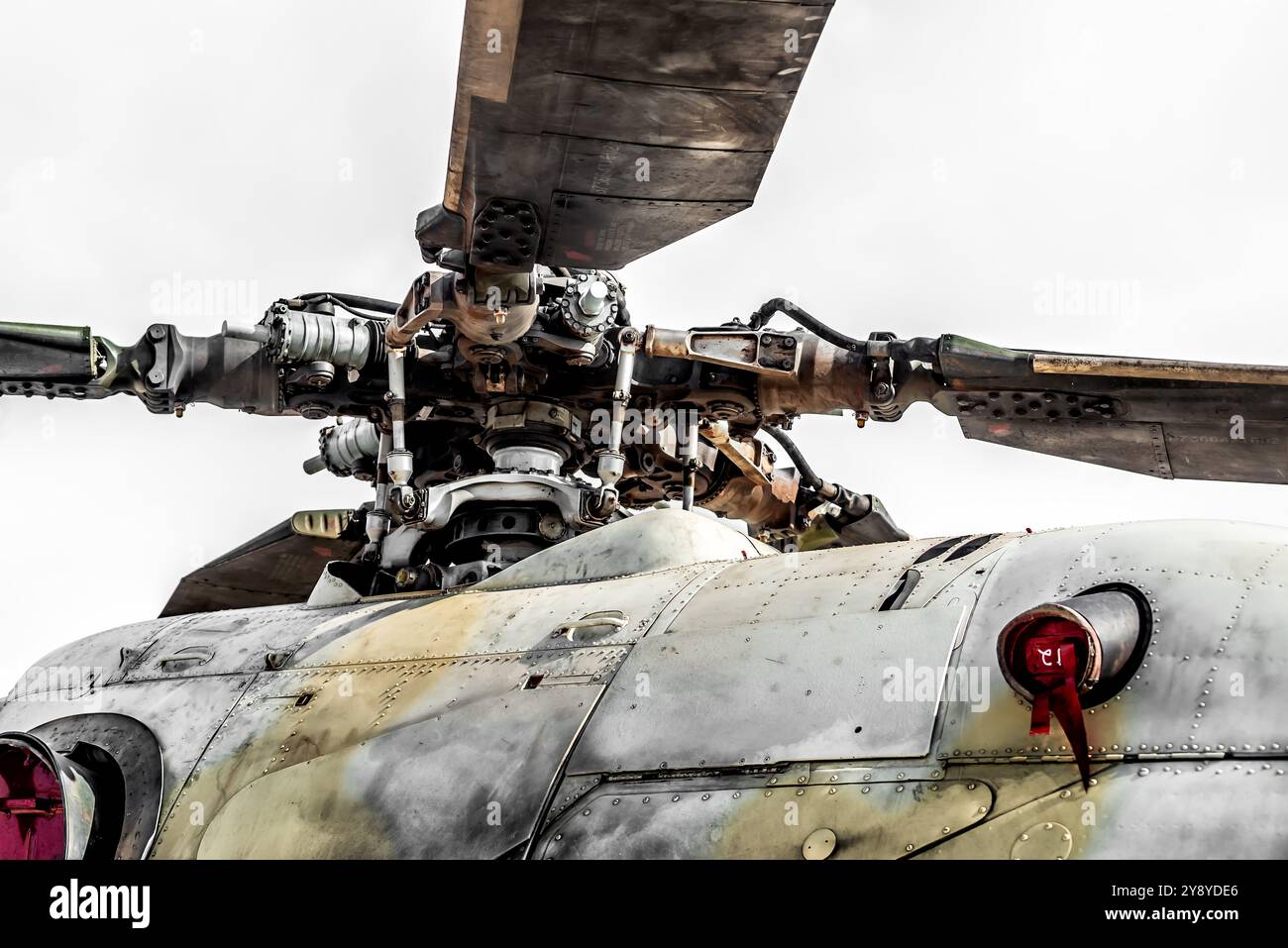 Military helicopter's rotor head and blades stand out against a sky ...