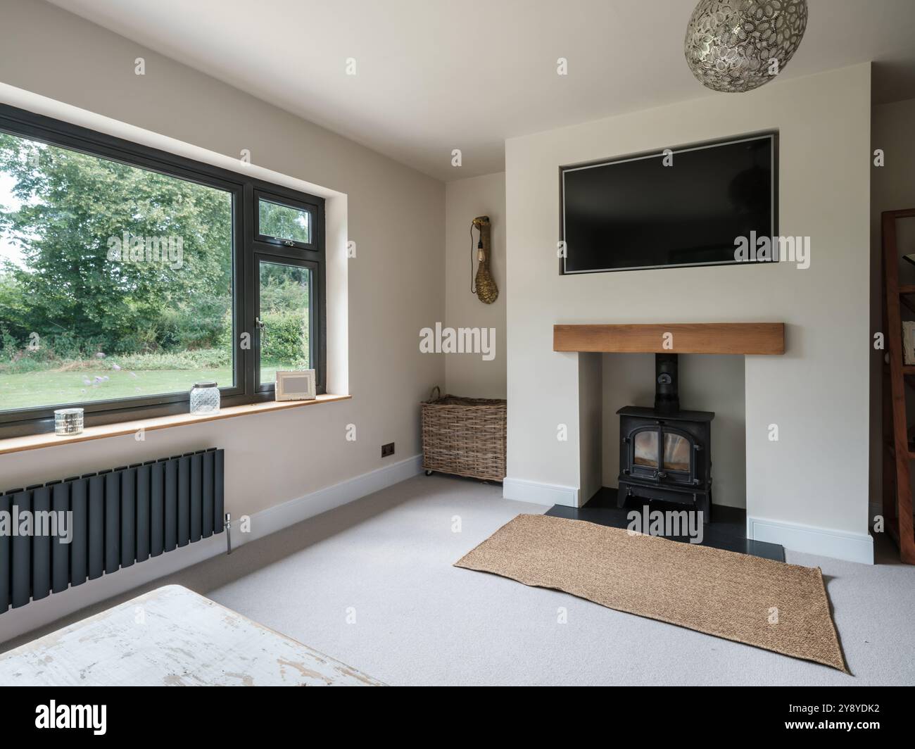 Furnished living room with contemorary radiator and large picture ...