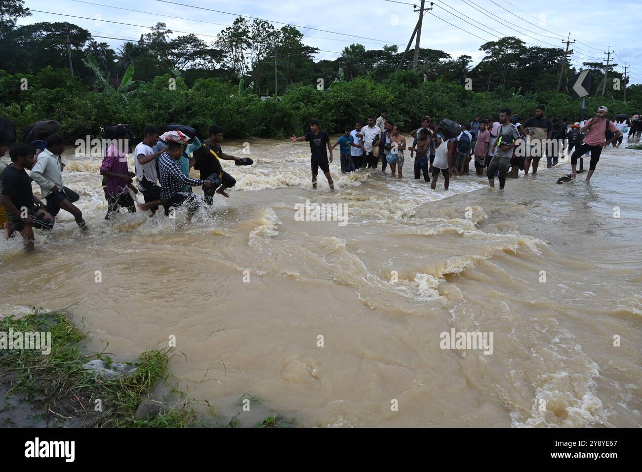 People wade through floodwaters in Feni District, Bangladesh, on August ...
