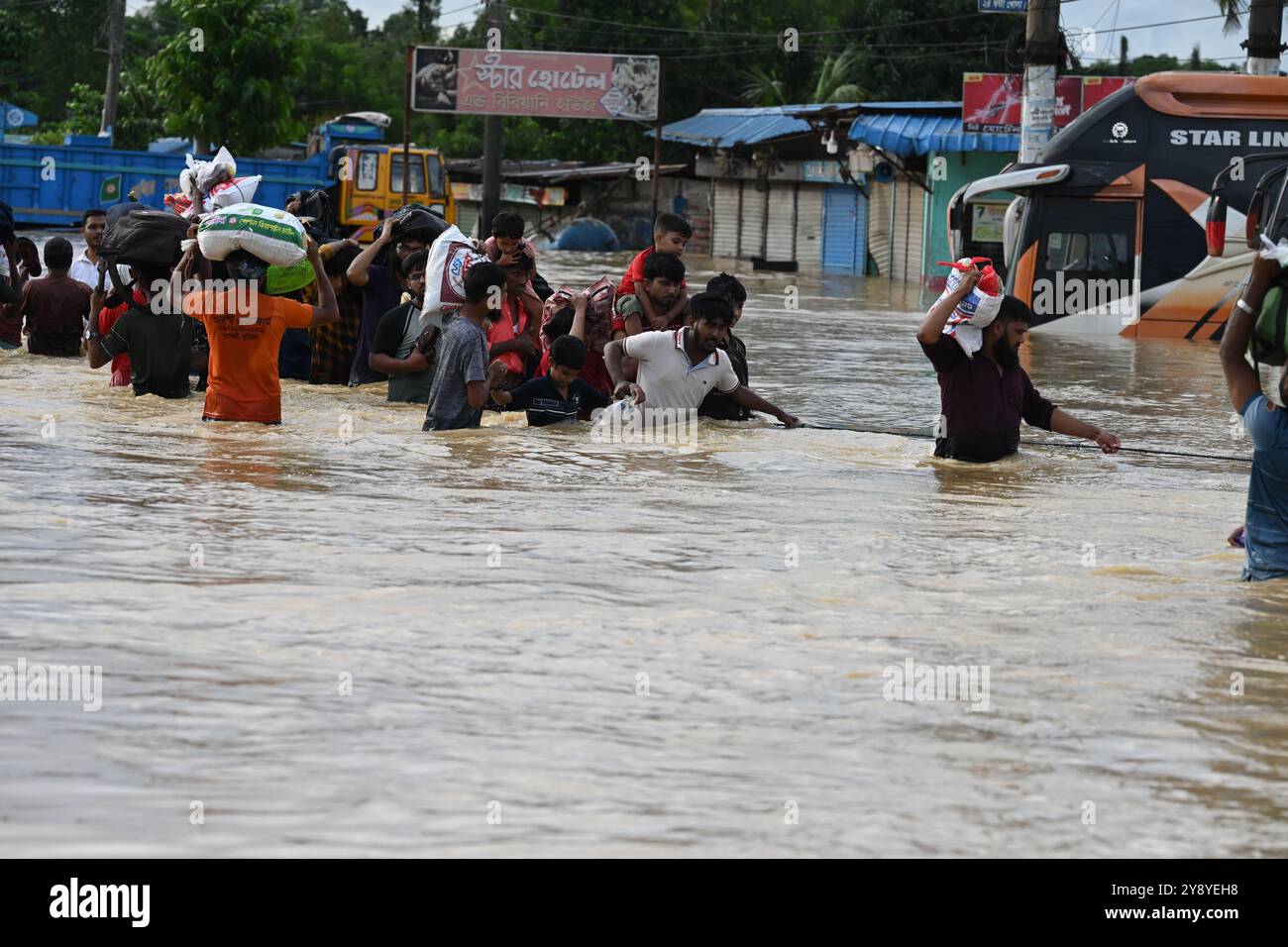People wade through floodwaters in Feni District, Bangladesh, on August ...