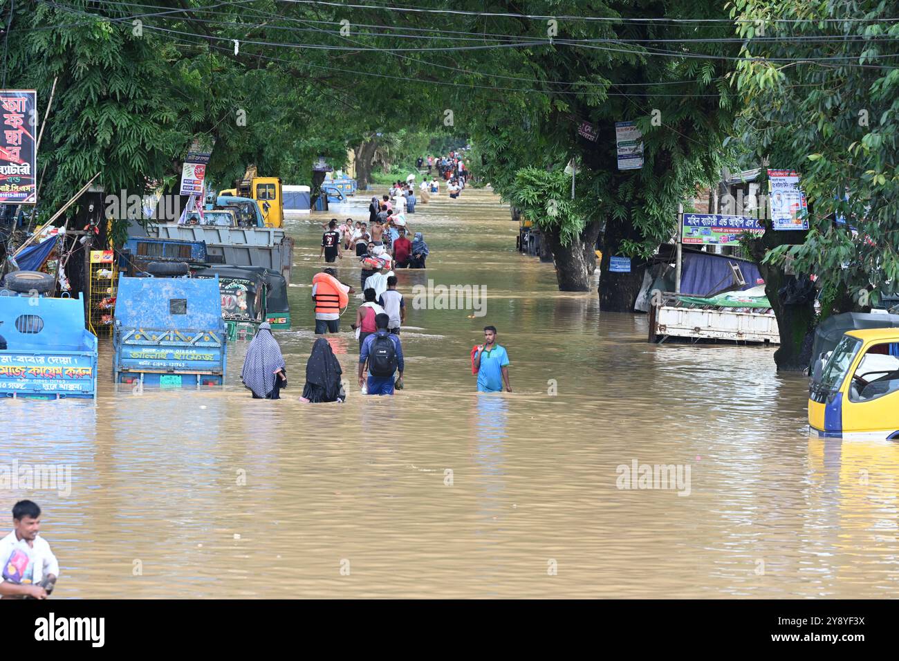 People wade through floodwaters in Feni District, Bangladesh, on August ...