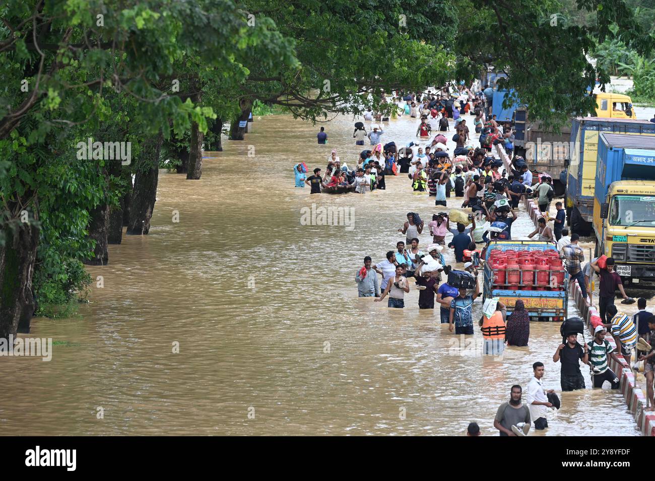 People wade through floodwaters in Feni District, Bangladesh, on August ...
