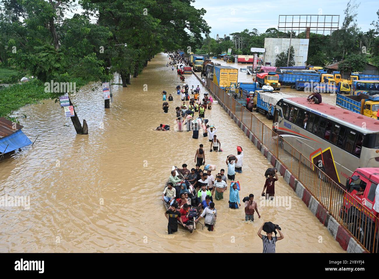 People wade through floodwaters in Feni District, Bangladesh, on August ...