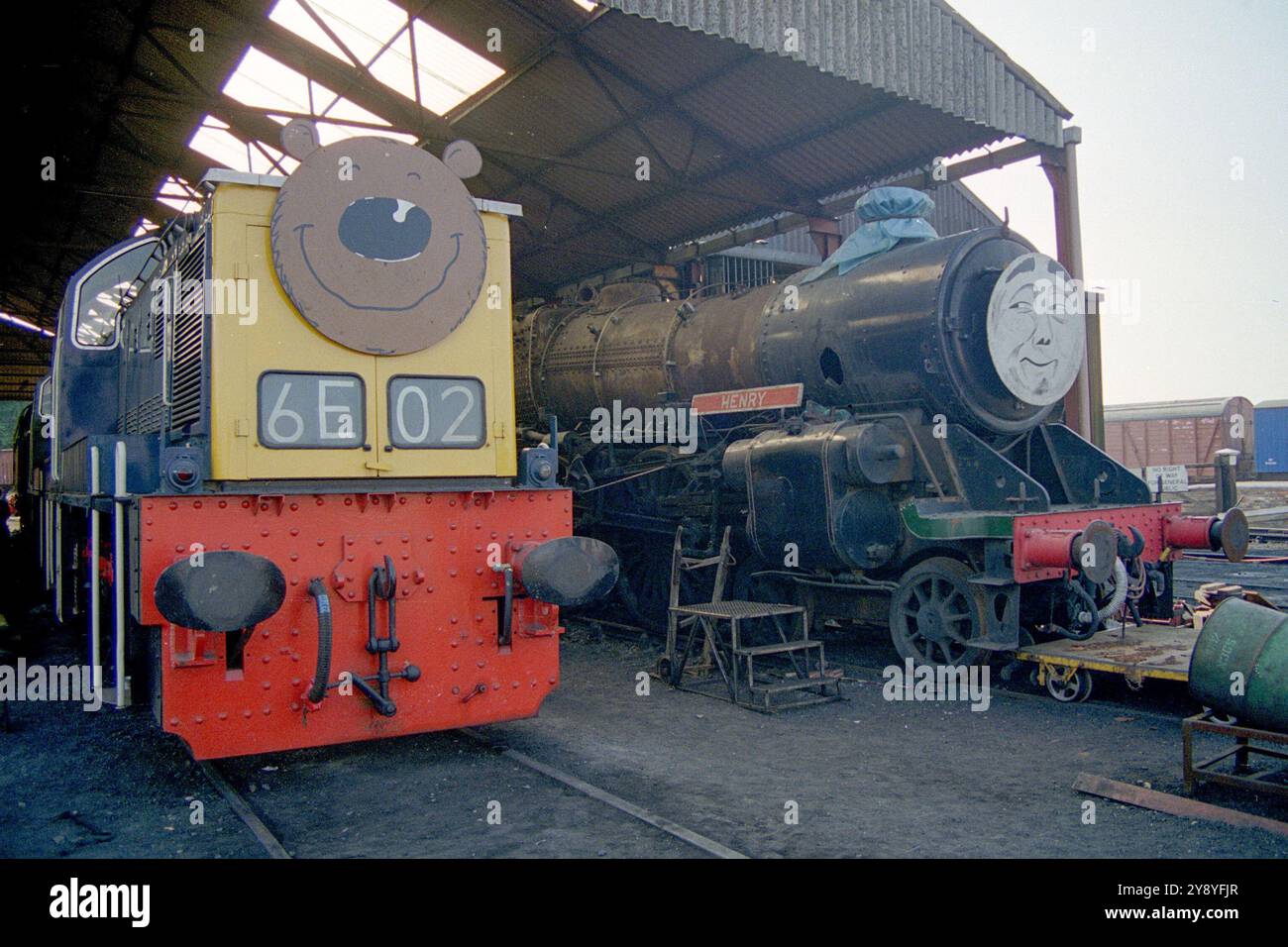 A diesel and a steam locomotive with faces at the Nene Valley Railway ...