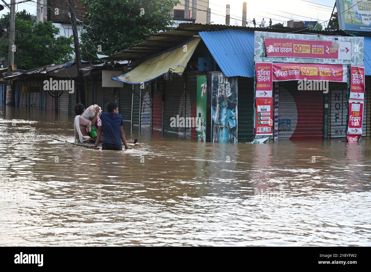 People wade through floodwaters in Feni District, Bangladesh, on August ...