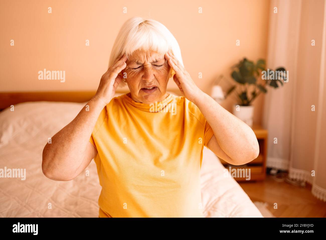 Stressed frustrated middle aged lady suffering from headache massaging ...