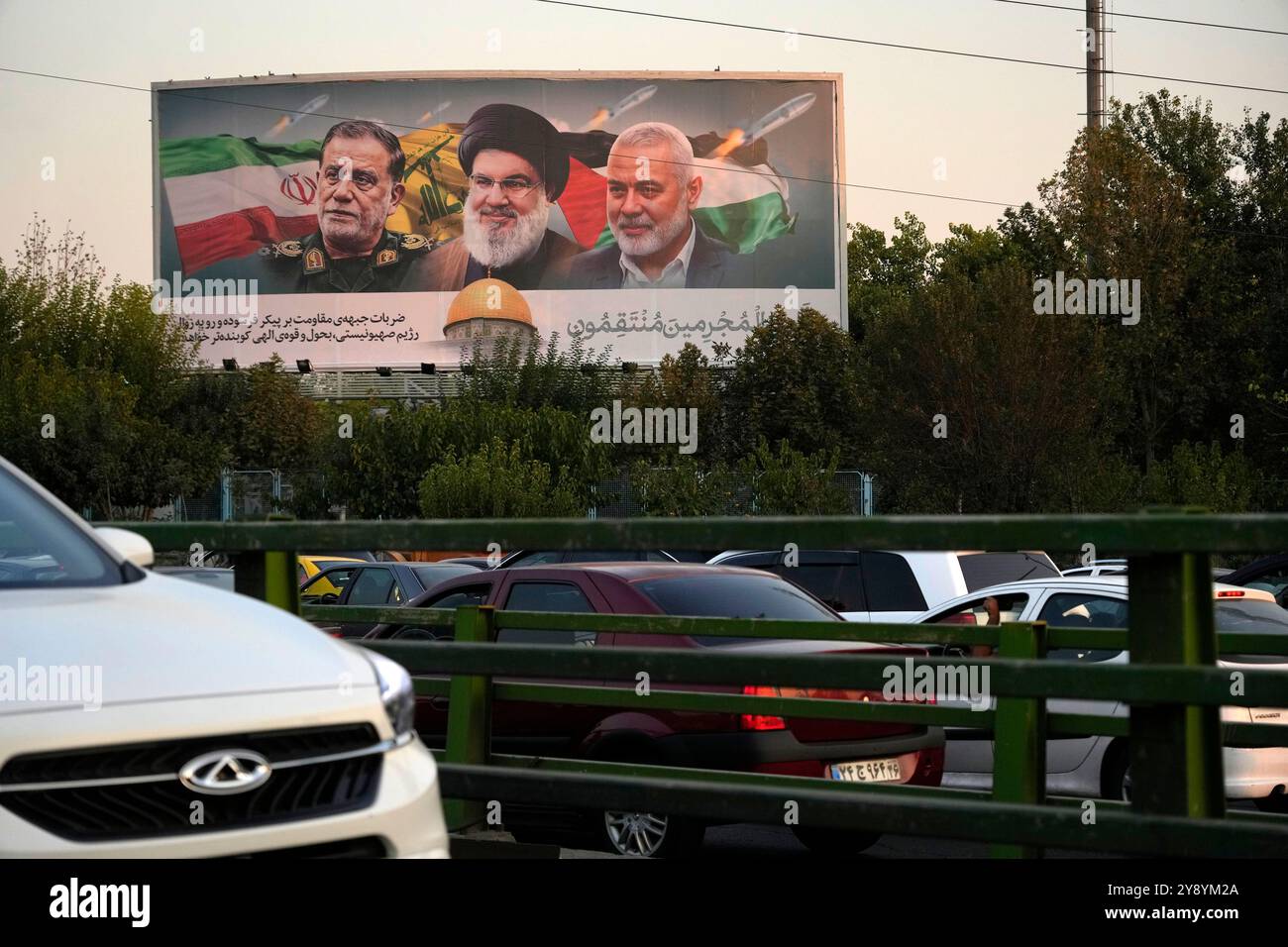 Vehicles drive past a billboard on a highway in Tehran, Iran, Monday ...