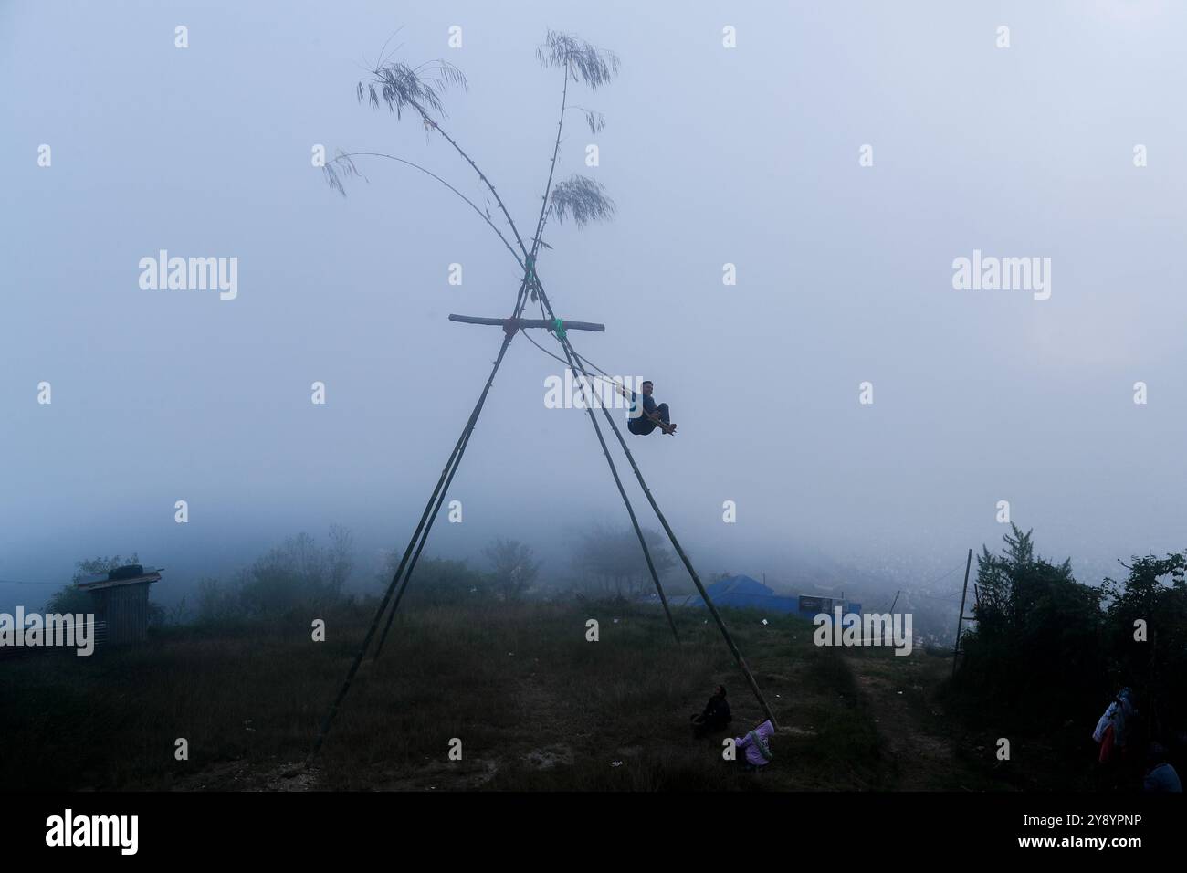Kathmandu, Nepal. 07th Oct, 2024. People play in a traditional bamboo ...