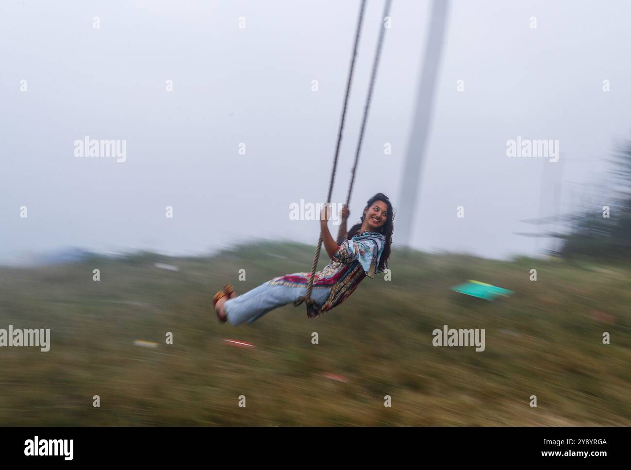 Kathmandu, Nepal. 07th Oct, 2024. A woman smiles while playing in a ...