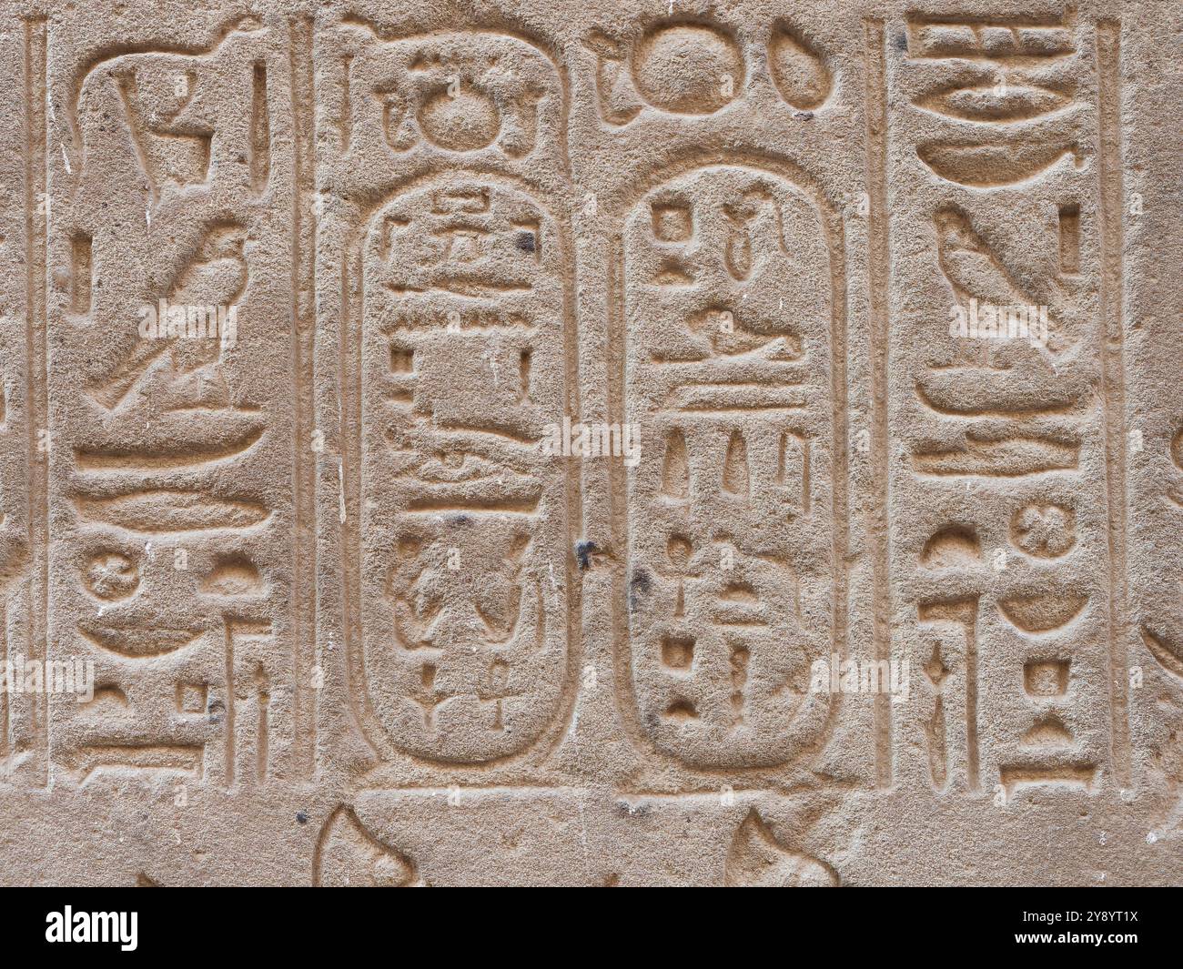 Egyptian hieroglyphic engravings on the stone walls of the temple of ...