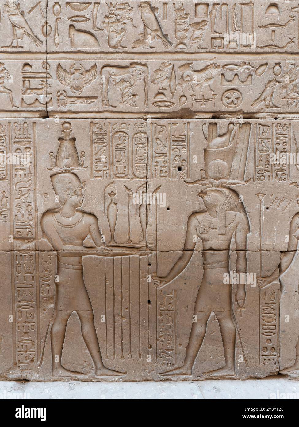 Egyptian hieroglyphic engravings on the stone walls of the temple of ...