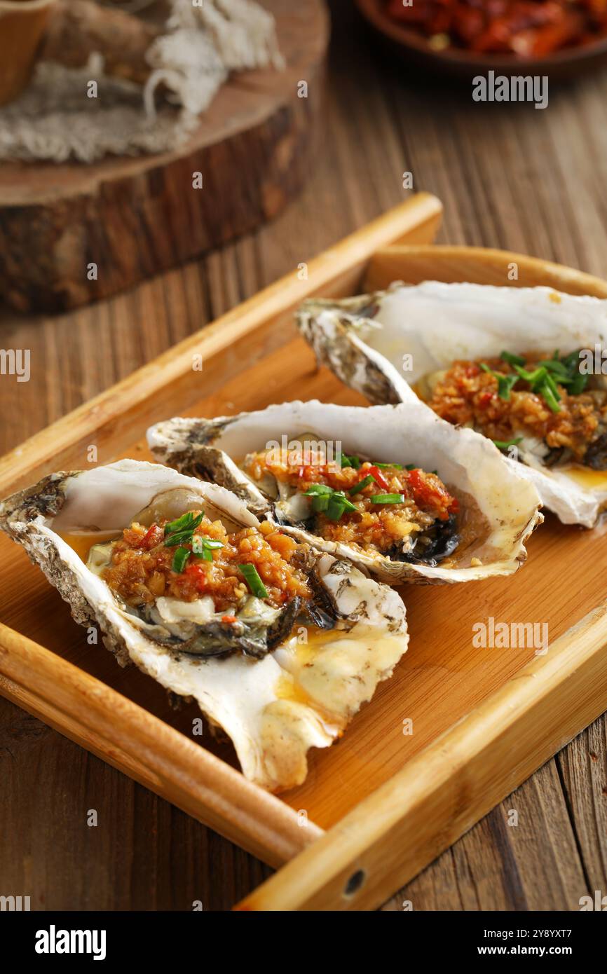 Grilled oysters with Garlic.Japanese grilled oyster barbecue outside ...