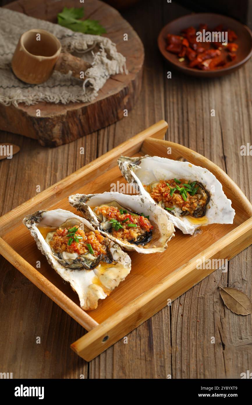 Grilled oysters with Garlic.Japanese grilled oyster barbecue outside ...