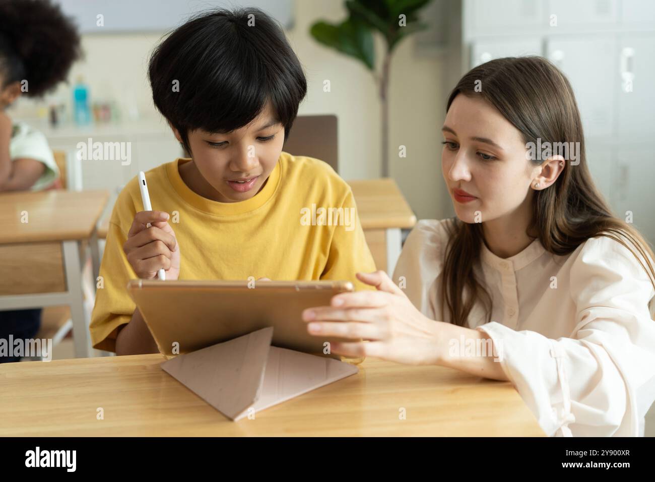 Teacher Guiding Student with Digital Learning in Diverse Classroom ...