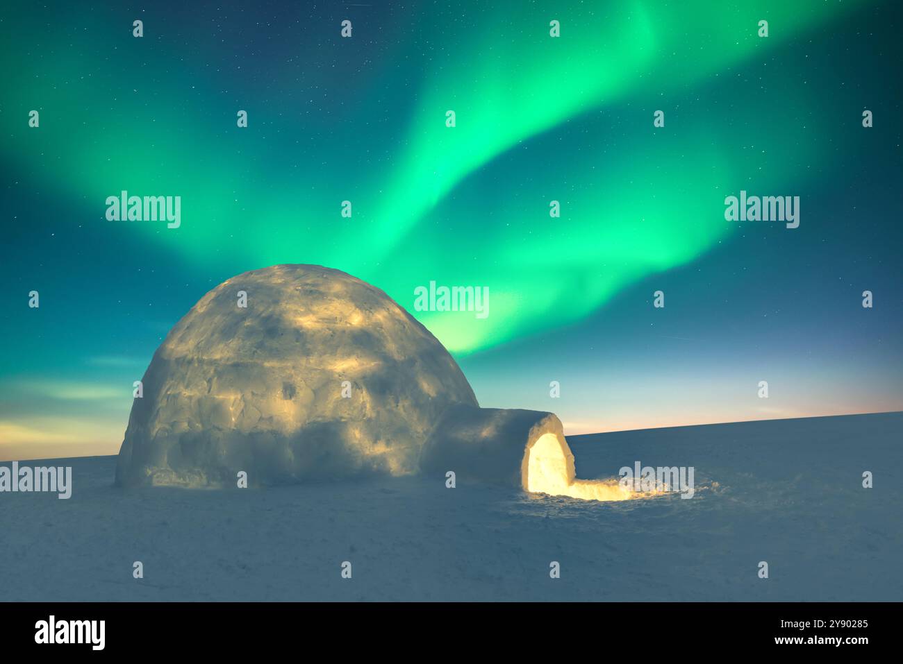 Snowy igloo lighted from the inside against the backdrop of incredible ...