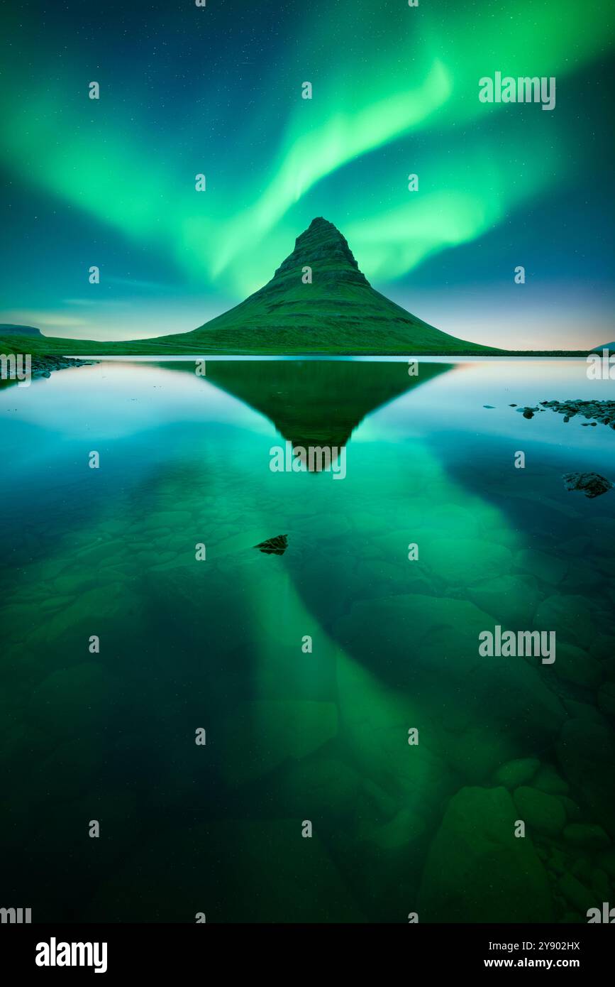 Reflection of Kirkjufell mountain and Polar lights in starry sky in ...